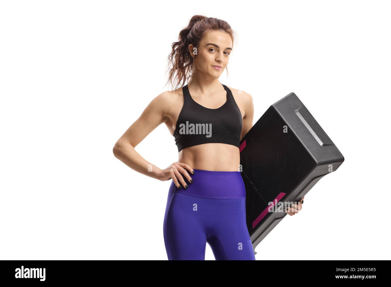 Young woman in sportswear holding a step aerobic platform isolated on ...
