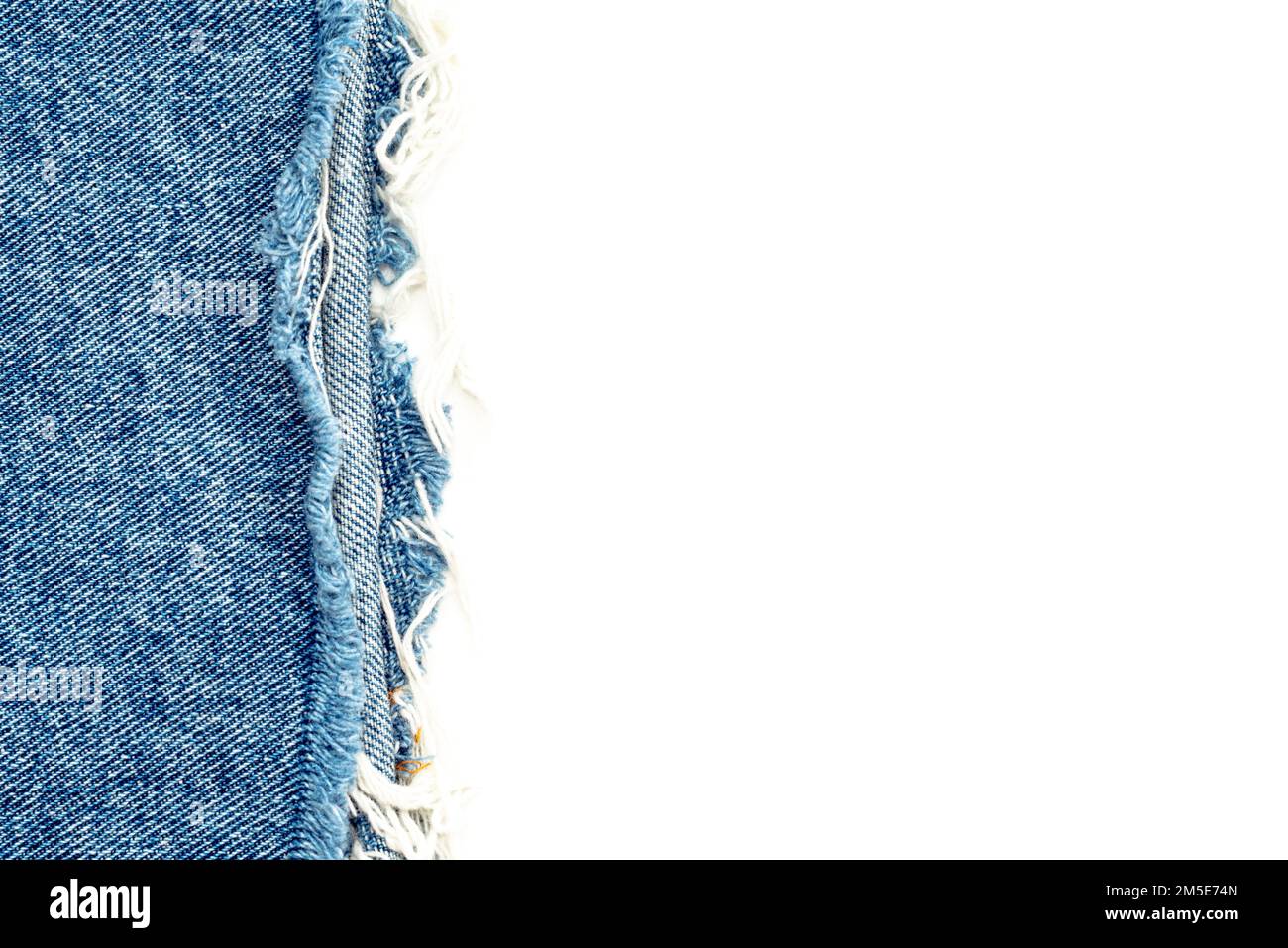 Frayed ripped jeans on a white background. Denim frame with empty space ...