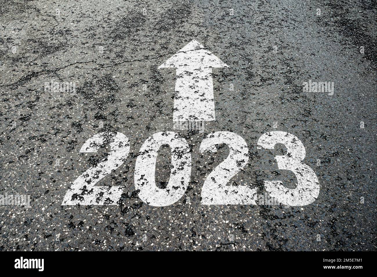 number 2023 and arrow pointing ahear on cracked asphalt, new year ...
