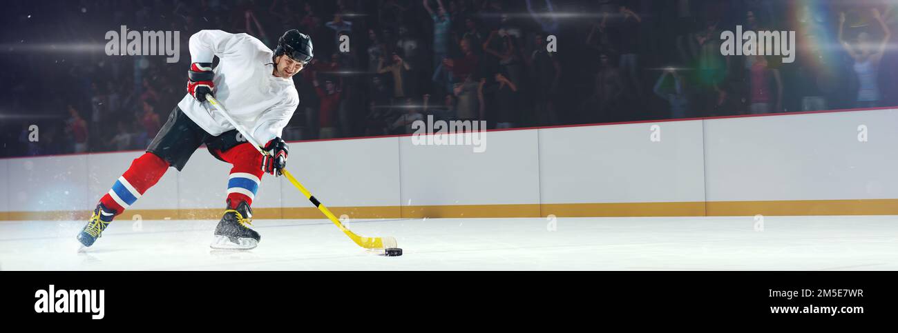 Man, professional hockey player in motion, playing, training over ice ...