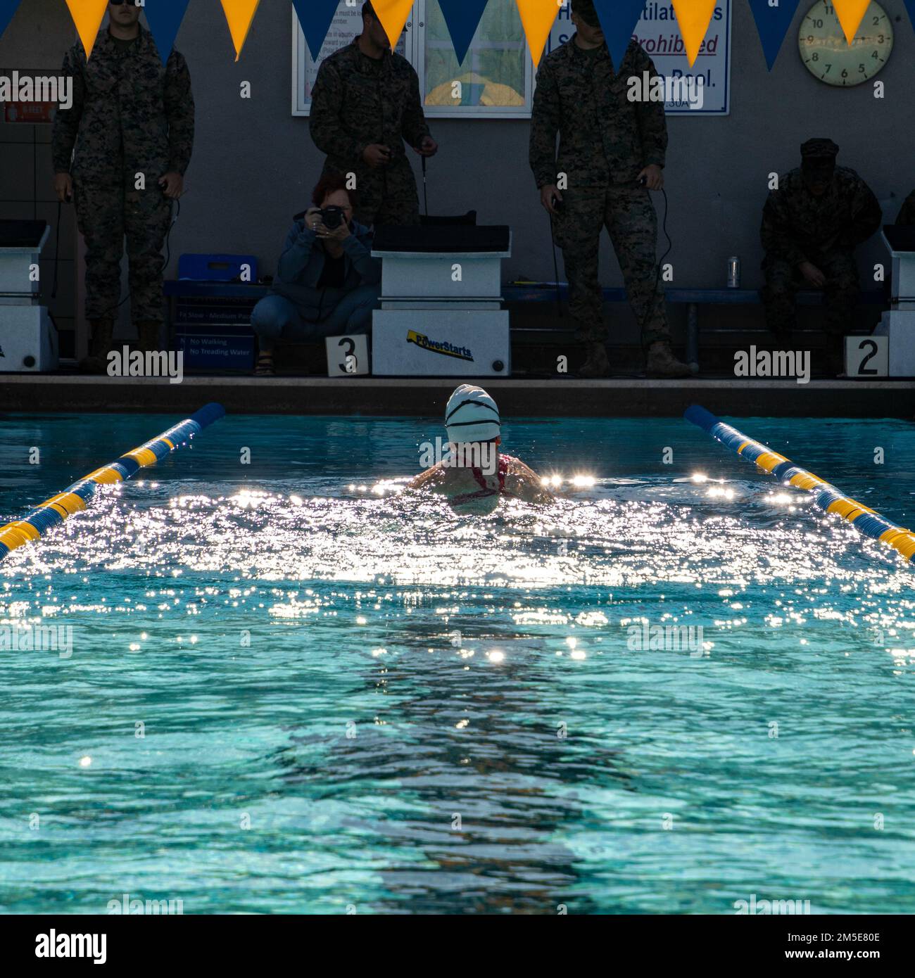 Retired U.S. Marine Corps Lance Cpl. Annika Hutsler leaps into the pool ...