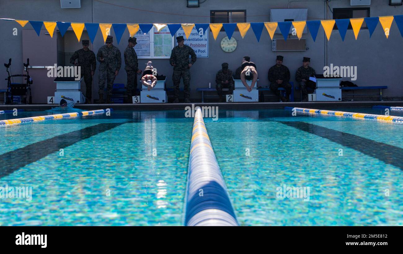 U.S. Marines leap into the pool for a swim competition during the 2022 ...
