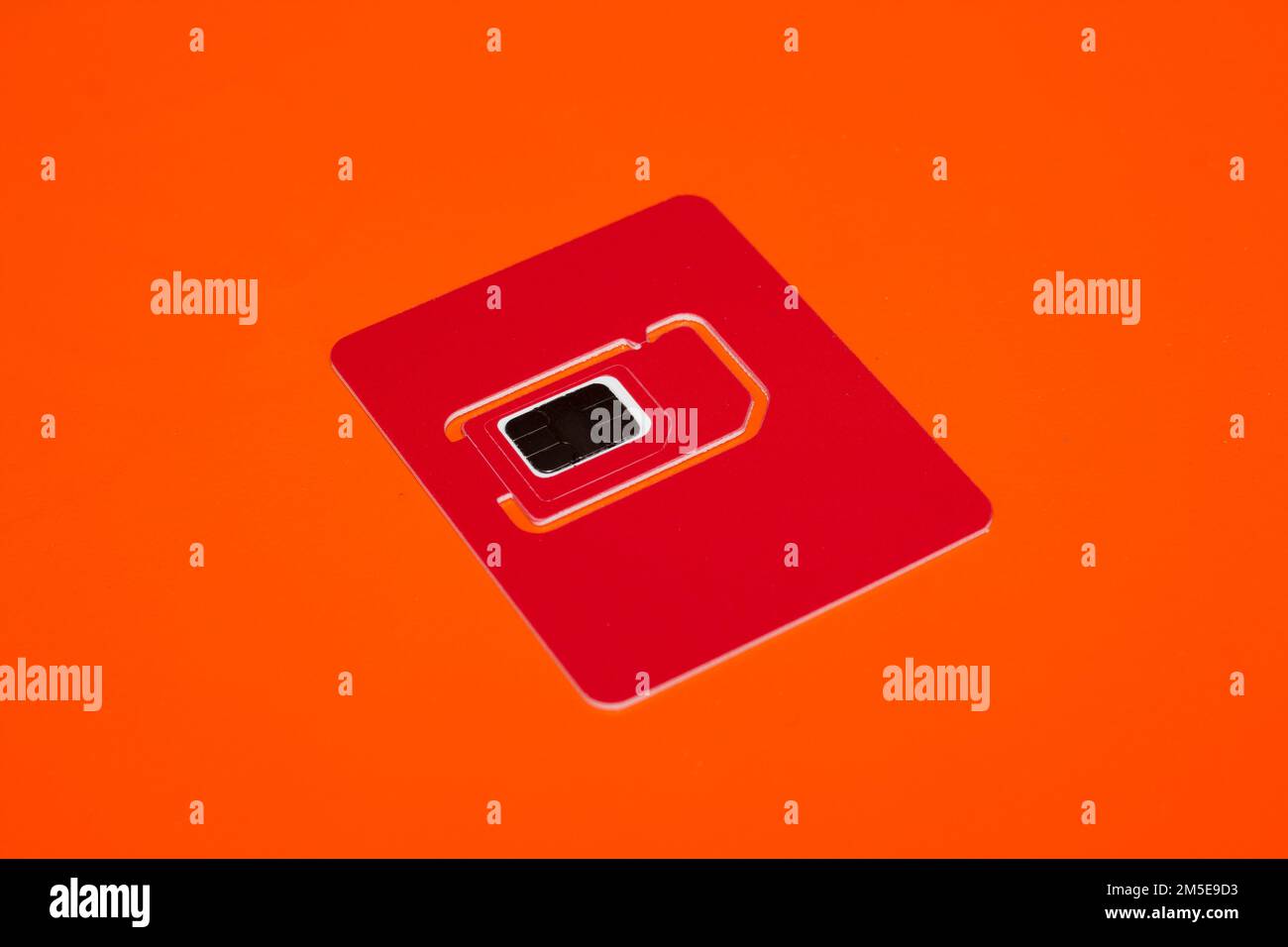 A 3D illustration of a red SIM card isolated on an orange background ...