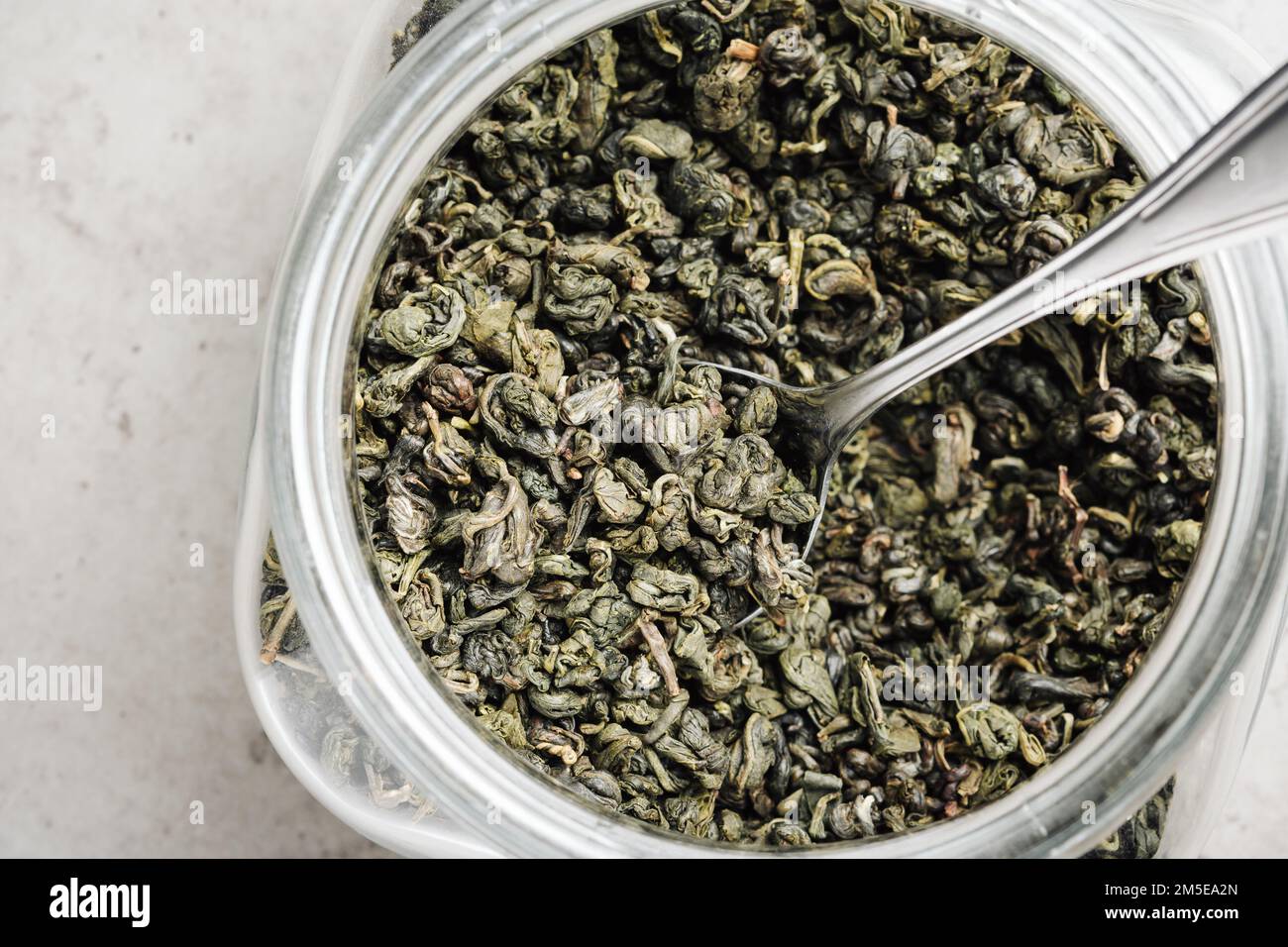 Dry green tea leaves in a jar close-up Stock Photo - Alamy