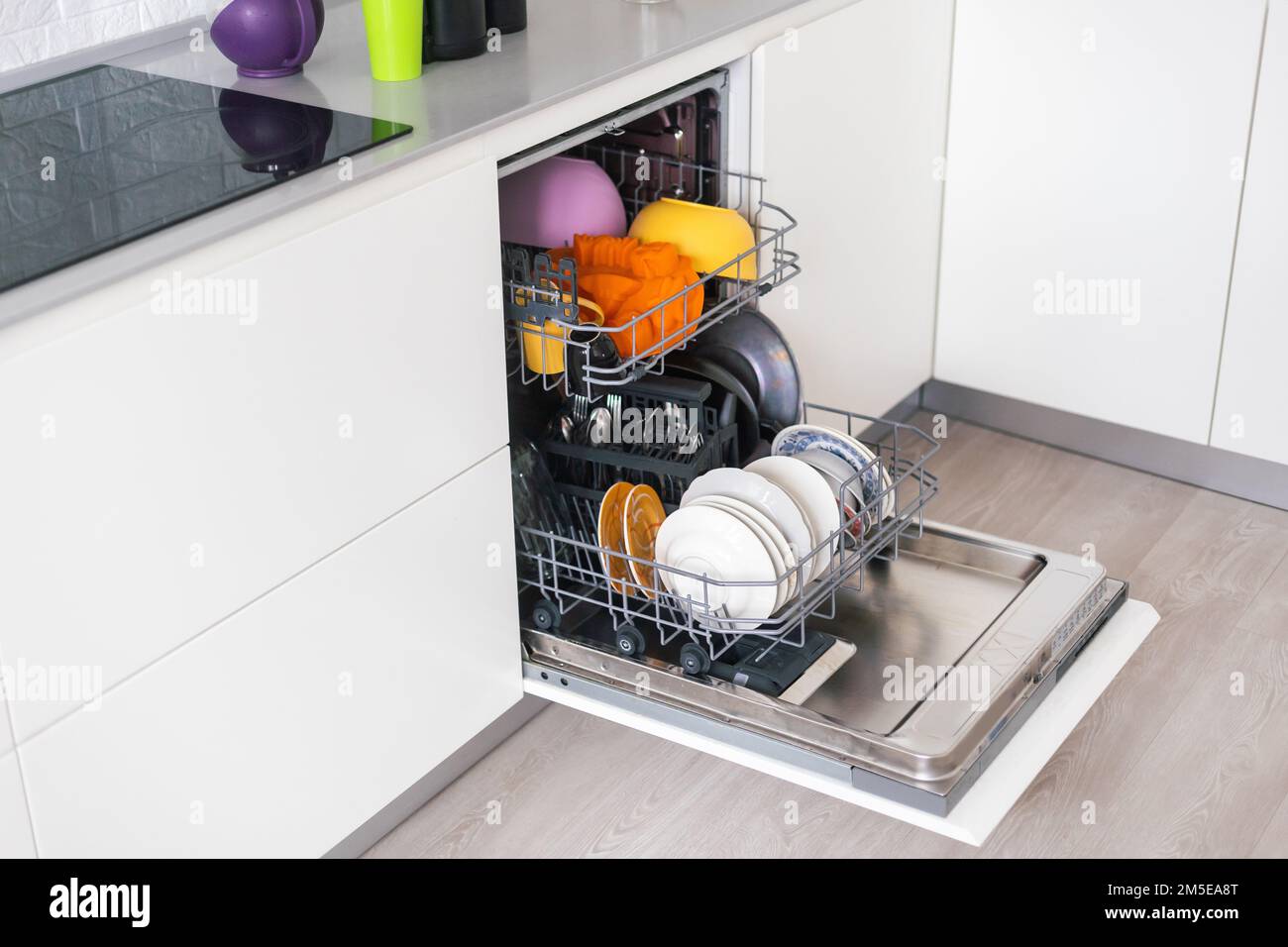 Open door of built-in dishwasher. Kitchen with integrated appliances ...