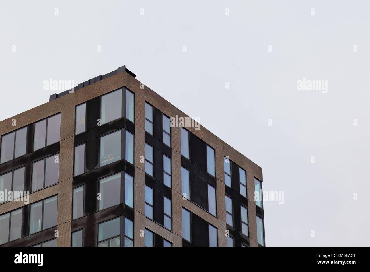 A modern high-rise building with glass windows Stock Photo - Alamy
