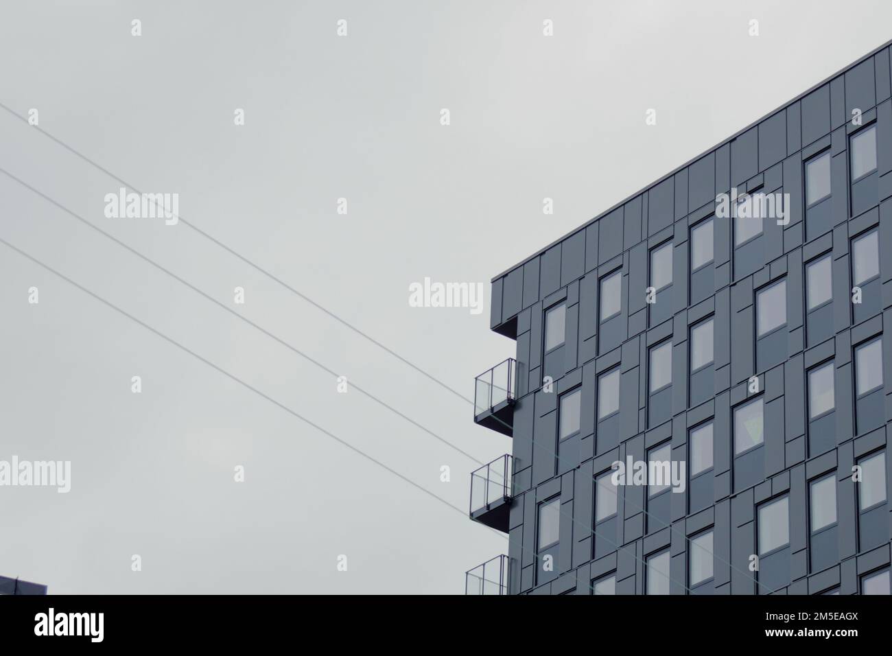 A modern high-rise building with glass windows and balconies Stock ...