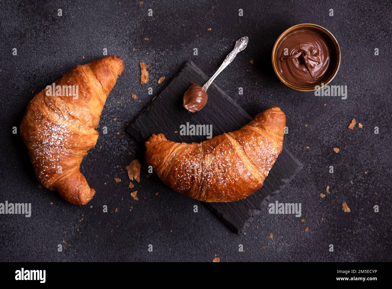 Delicious sweet croissant with chocolate on dark background Stock Photo ...