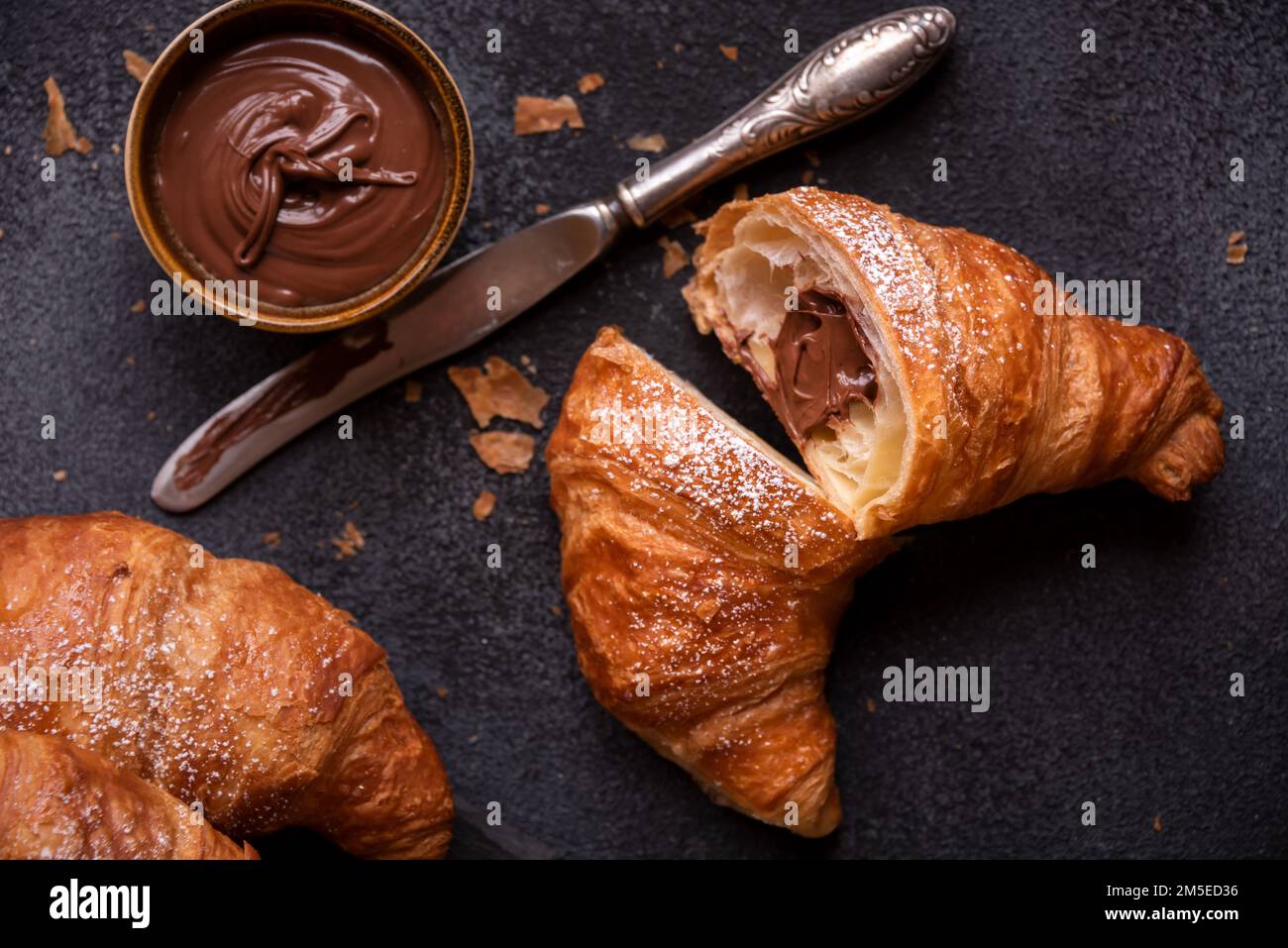 Delicious sweet croissant with chocolate on dark background Stock Photo ...