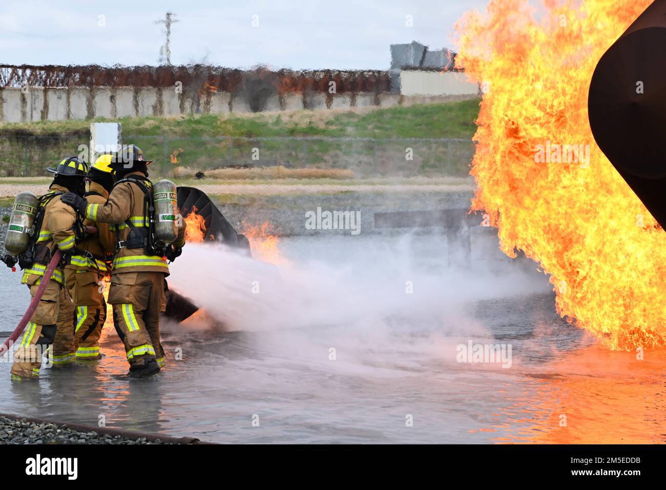 Firemen from the Shreveport Fire Department work together to hold and ...