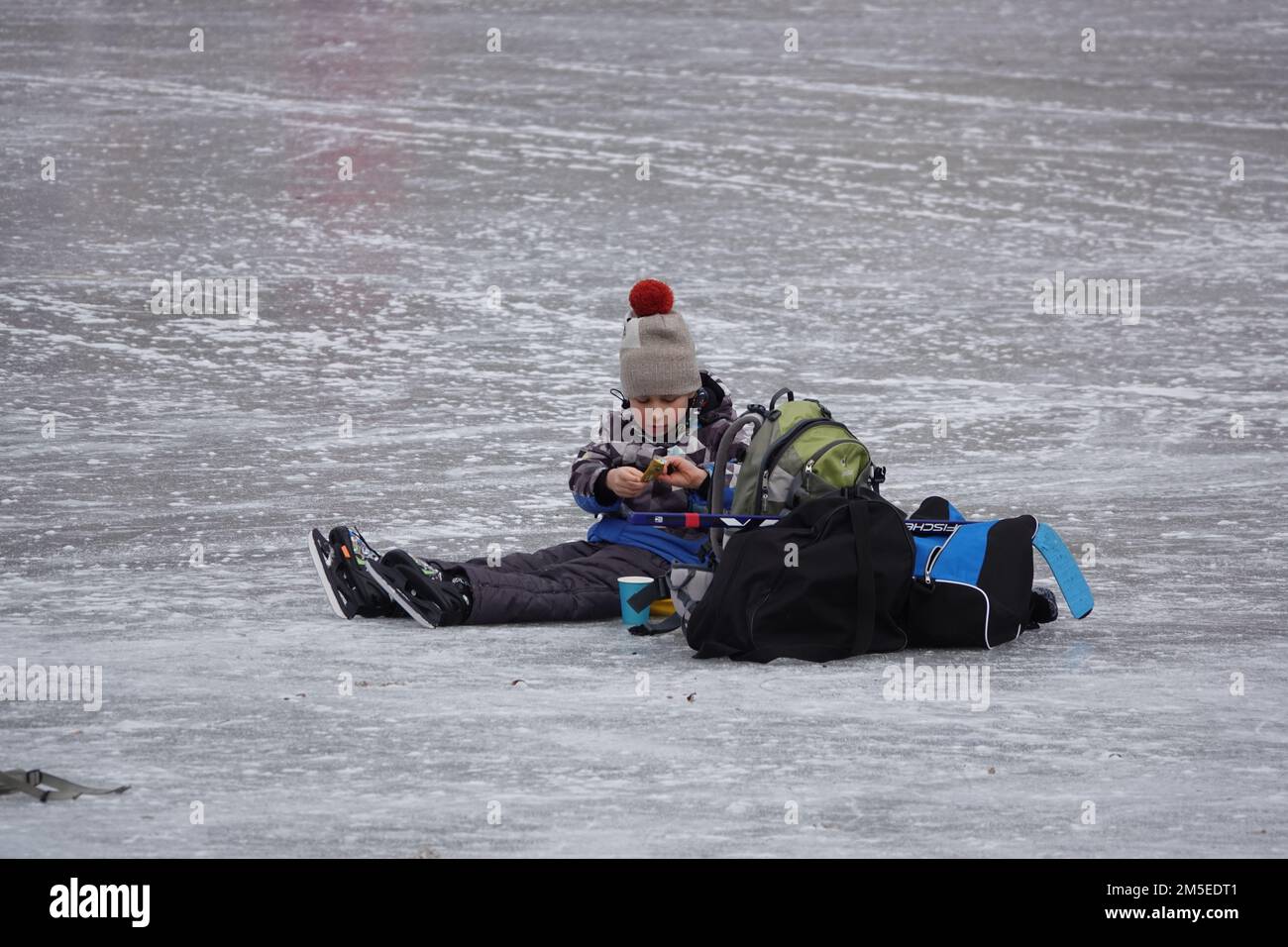 Kiev, Ukraine February 6, 2021: Children ride on the ice of a frozen ...
