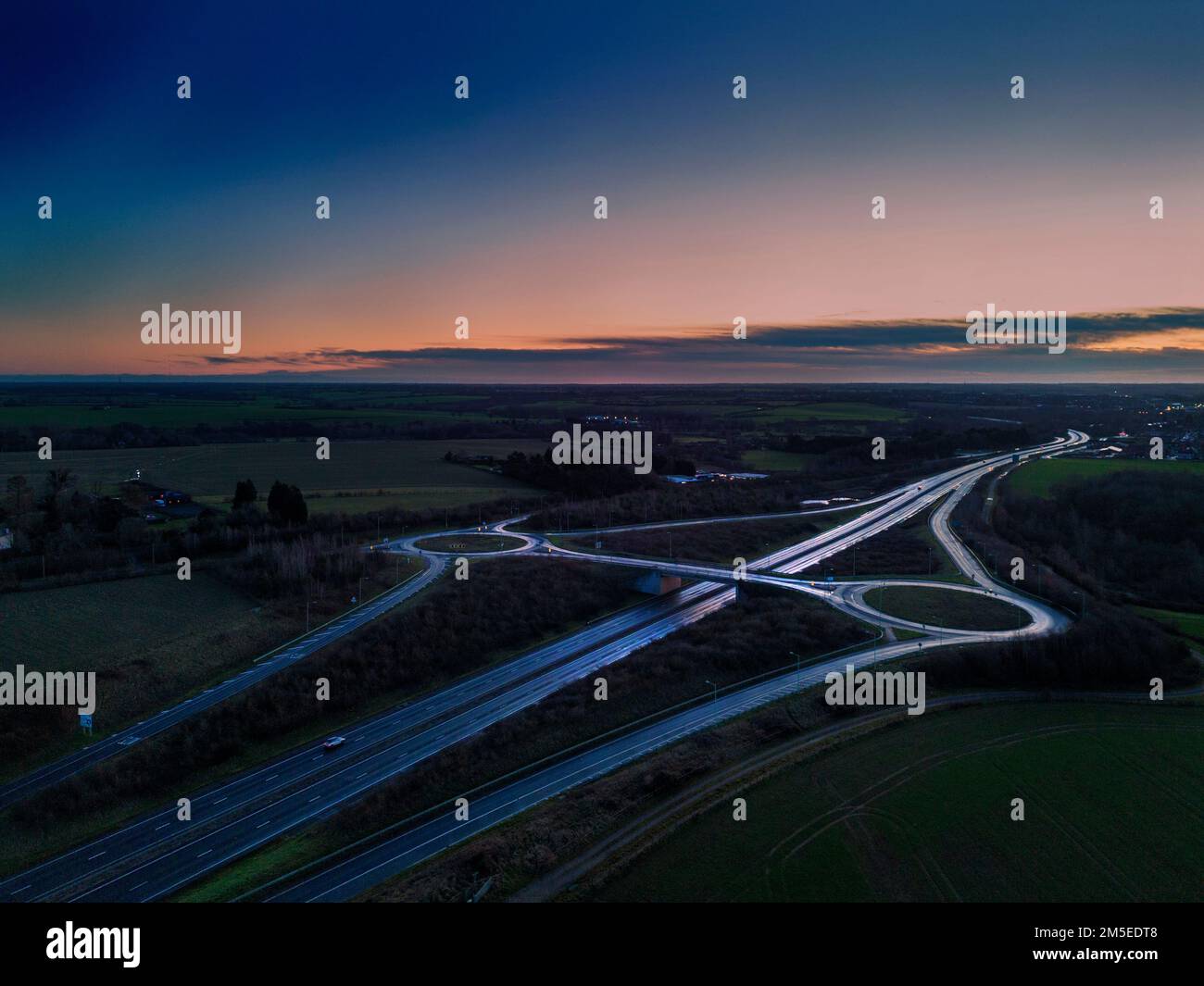 An aerial view of a junction on the A14 trunk road at dawn in Suffolk ...