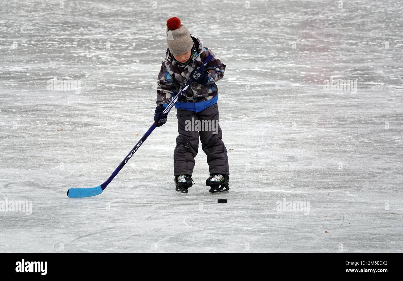Kiev, Ukraine February 6, 2021: Children ride on the ice of a frozen ...