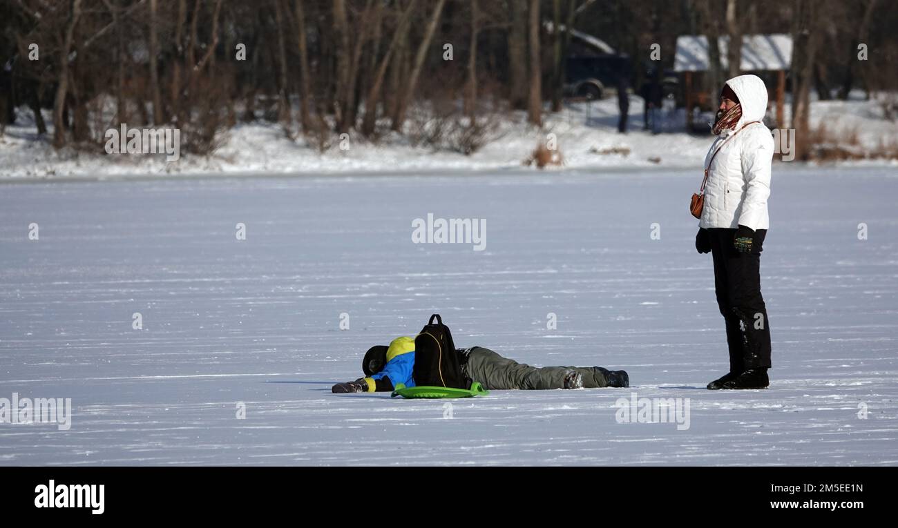 Kiev, Ukraine January 19, 2020: Children play in winter while riding on ...
