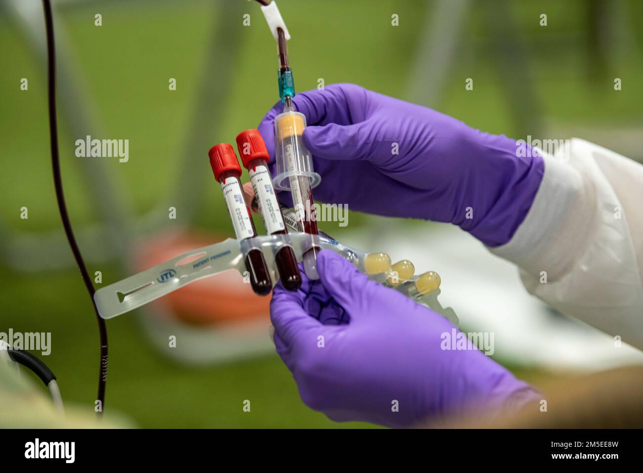 A phlebotomist holds blood collection tubes during the 2nd Annual Tri ...