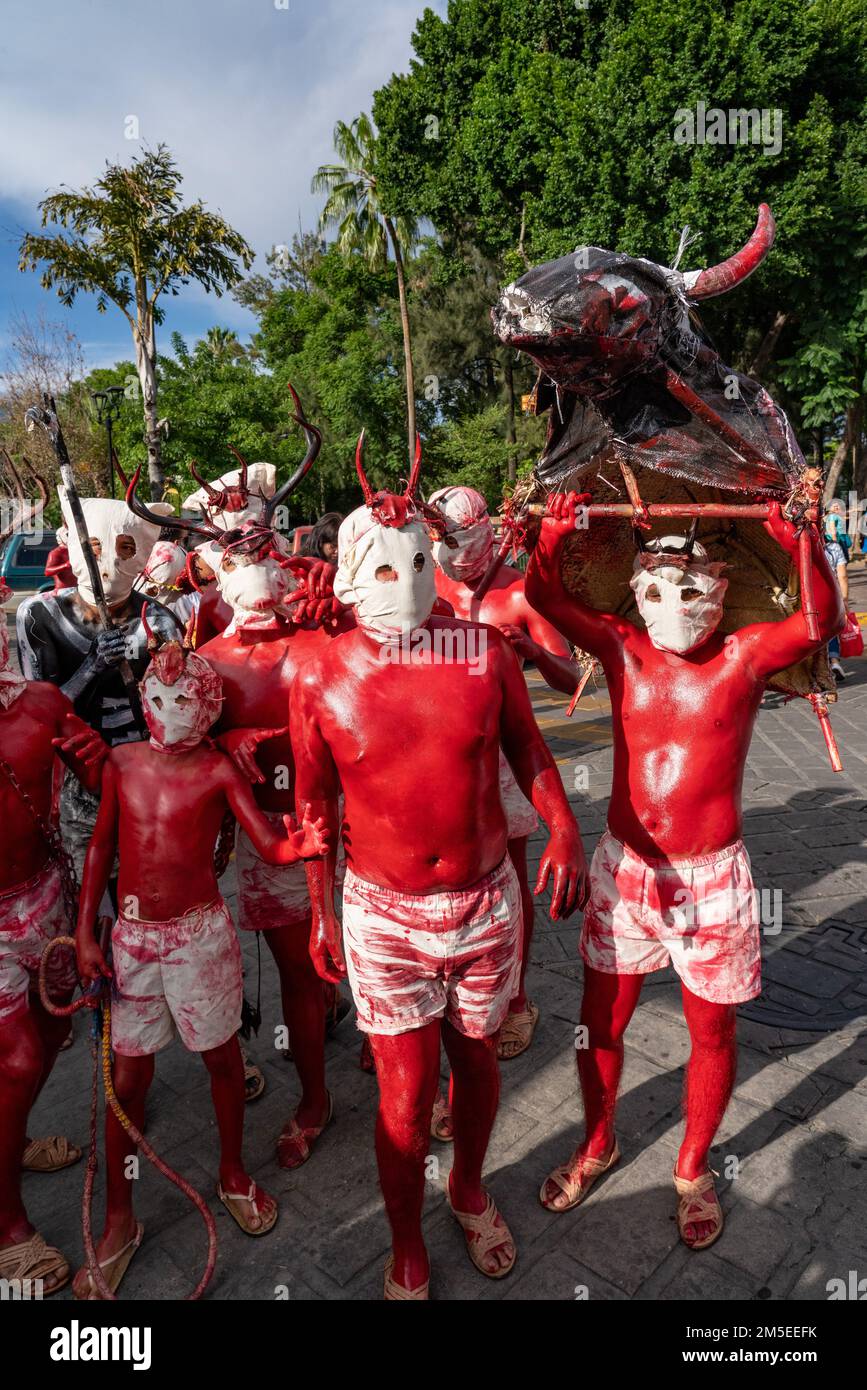 Painted devil dancers in costume at a parade for the Guelaguetza folk ...
