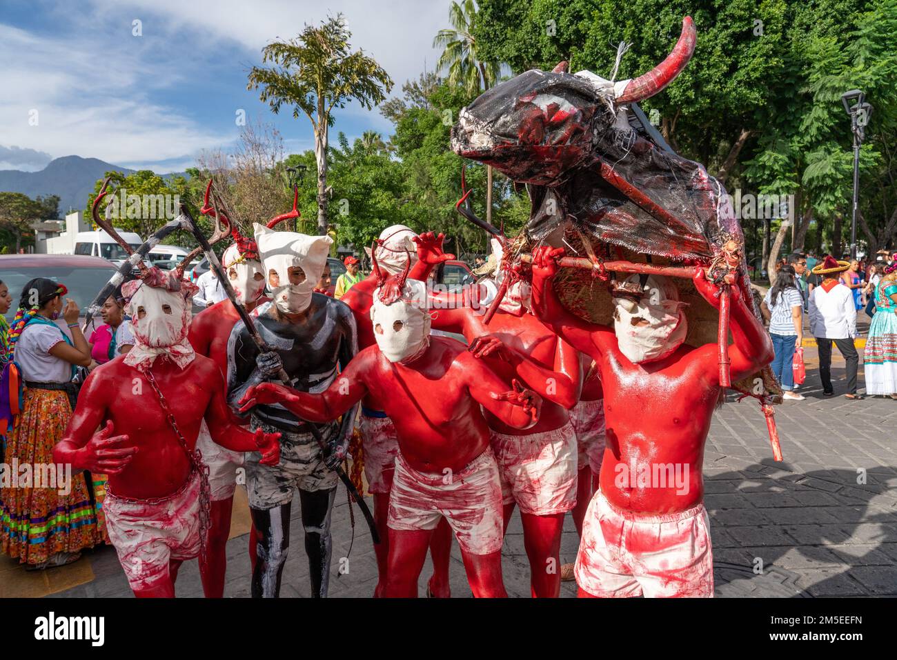 Painted devil dancers in costume at a parade for the Guelaguetza folk ...