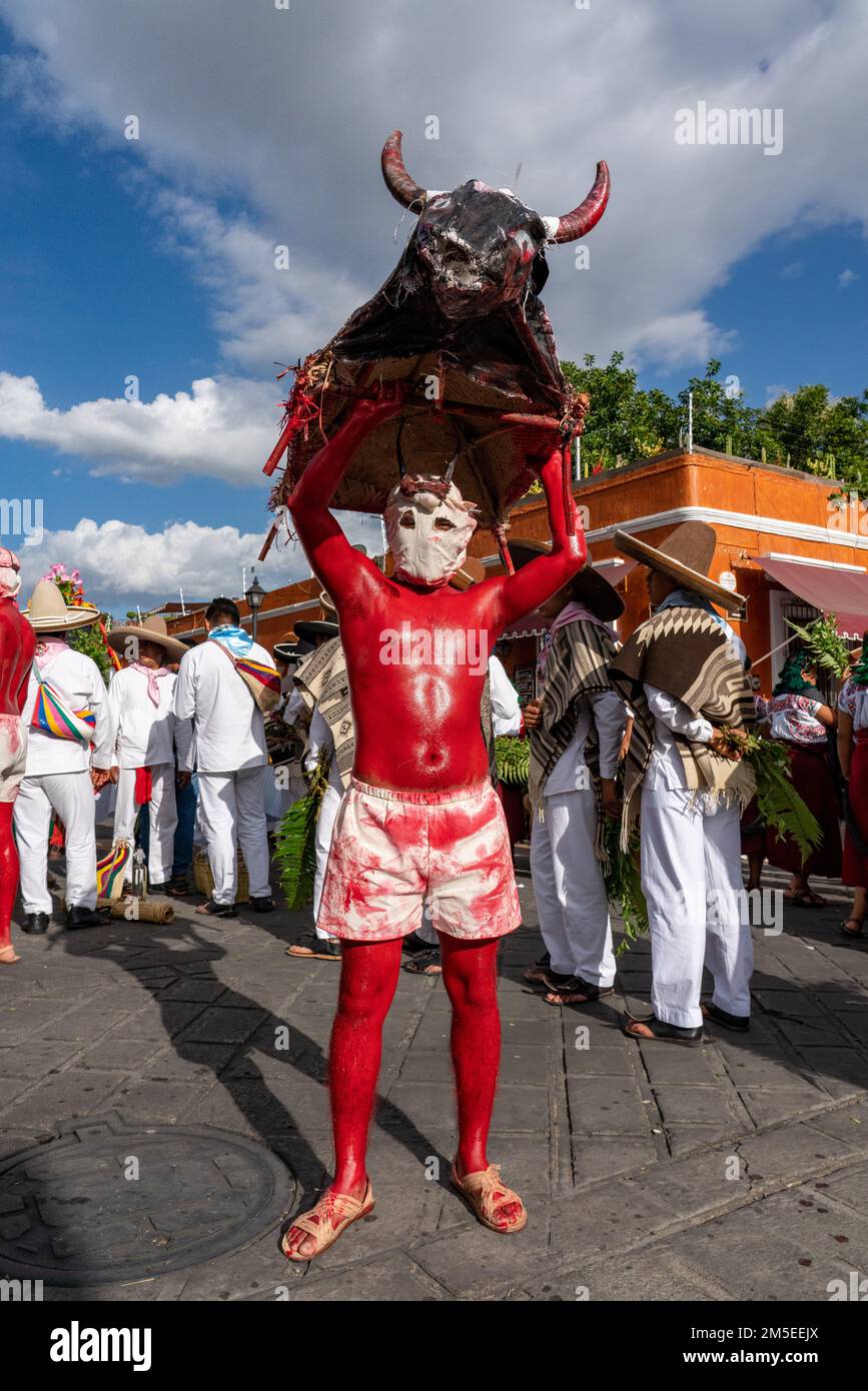 Painted devil dancers in costume at a parade for the Guelaguetza folk ...