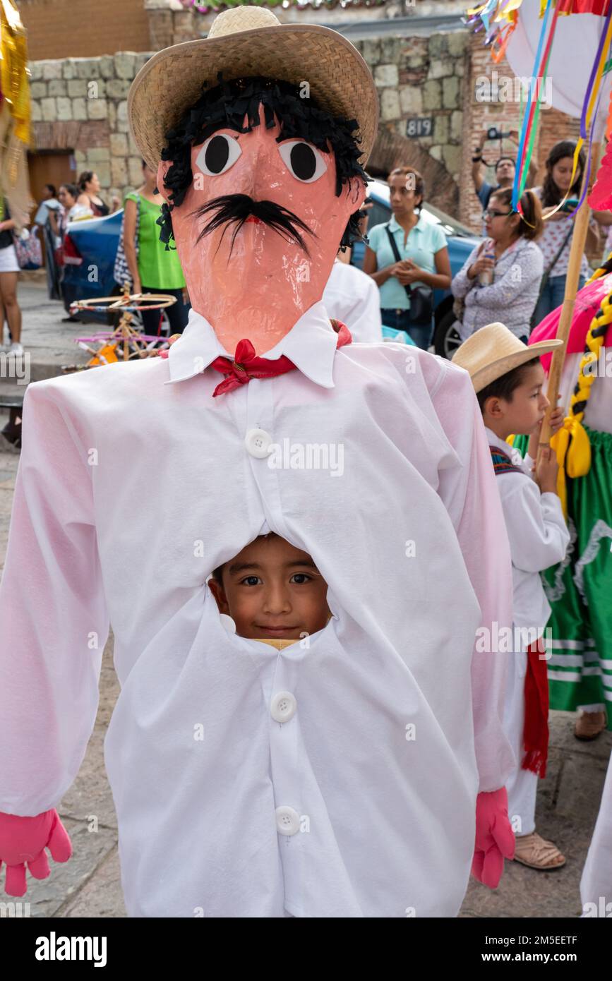 A young boy peeks out of his mono de calenda in a parade during the ...