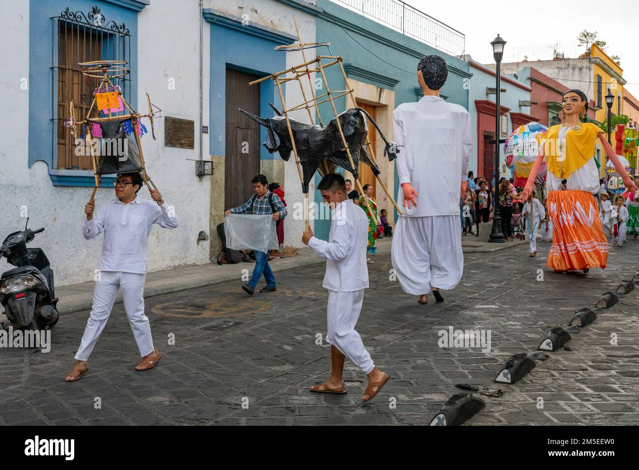 Boys with pinwheel fireworks bulls & giant puppets in a parade during ...