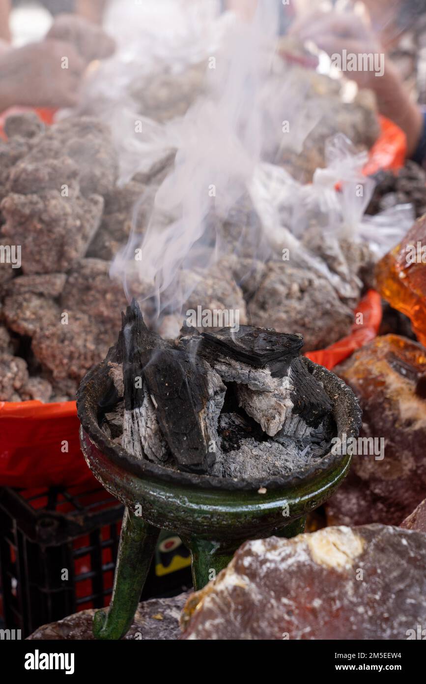Copal resin incense burning in a an incensed burner in a street market for celebrating the Dead ...