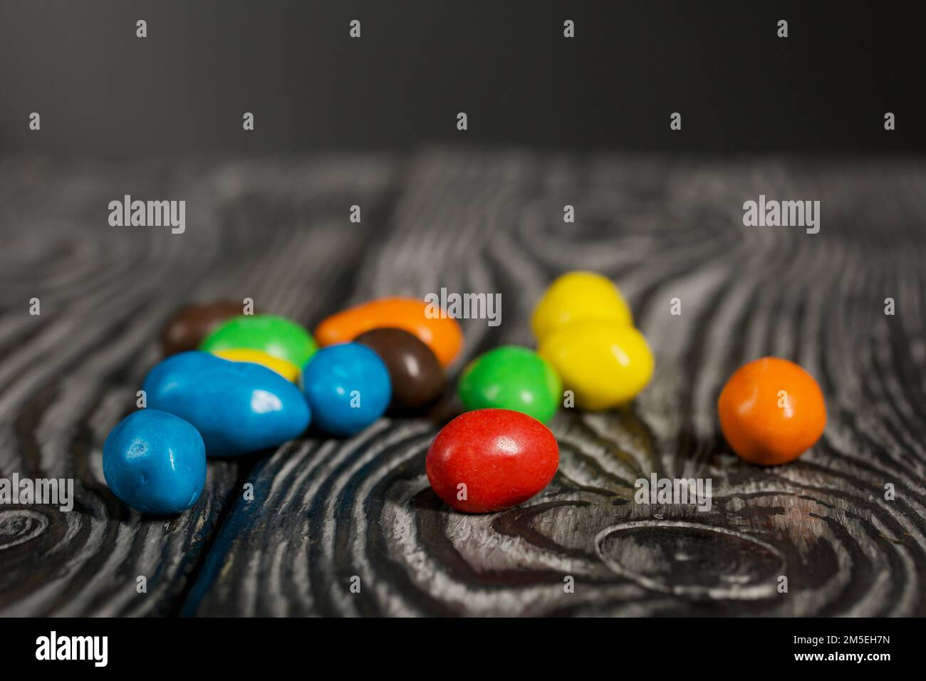 sweet dragees of different color on white background Stock Photo - Alamy