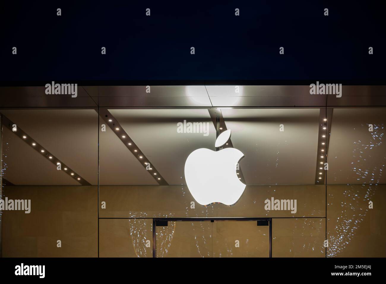 Illuminated Apple logo on the glass facade of Aix-en-provence Apple ...