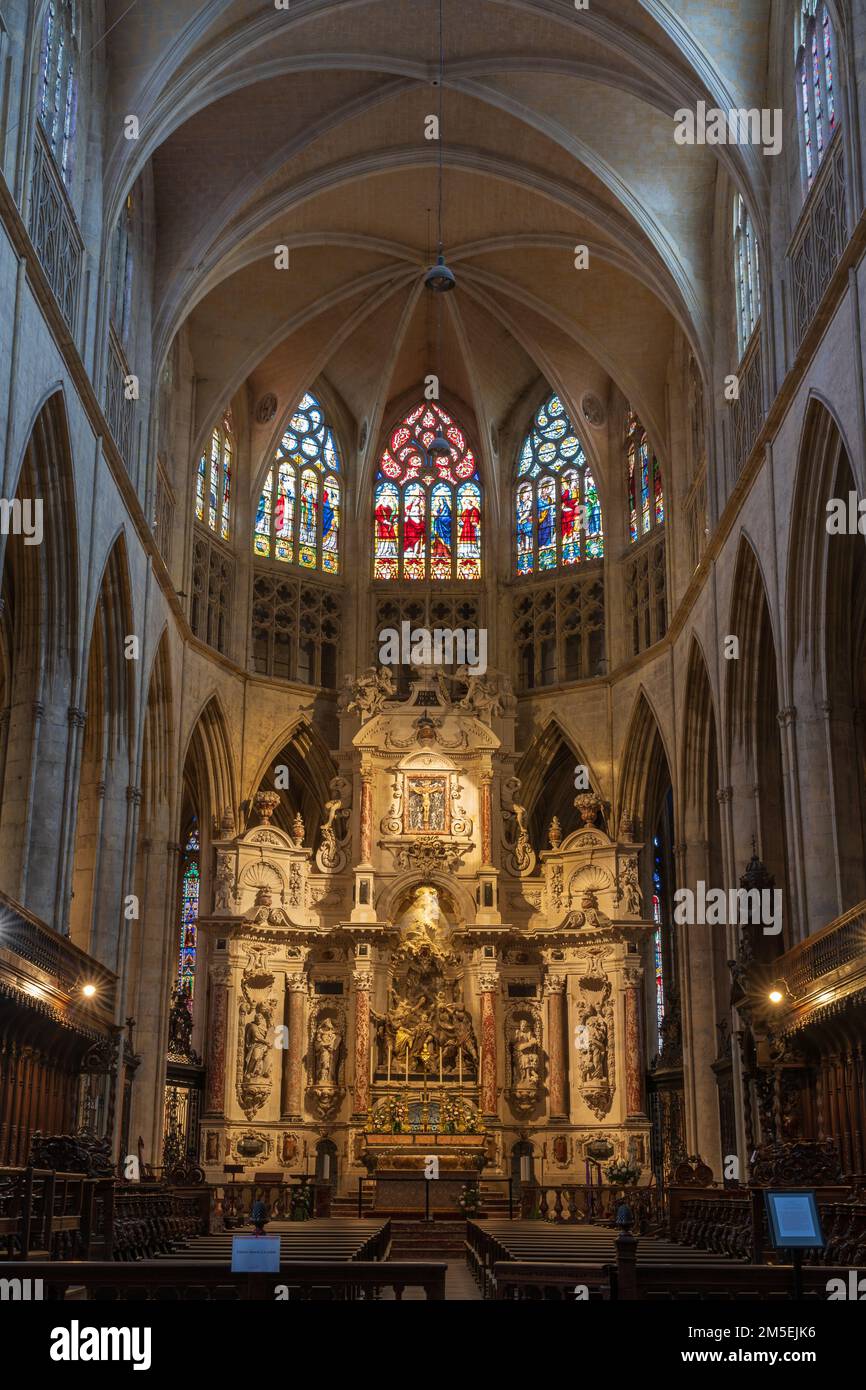 Vertical view of the choir and stained glass inside historic landmark ...