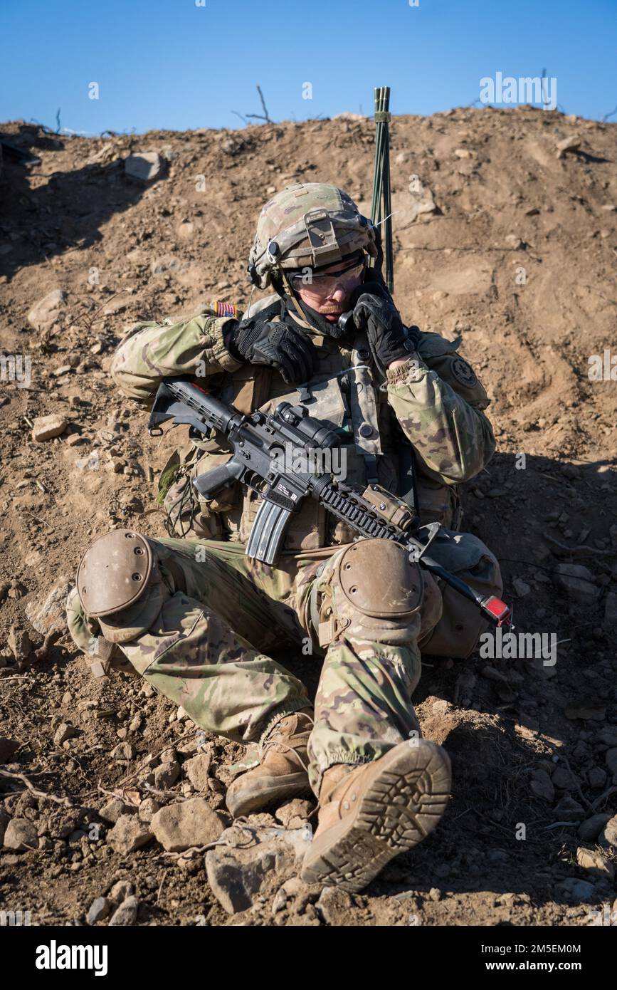 A U.S. Soldier assigned to the 2nd Cavalry Regiment communicates with ...