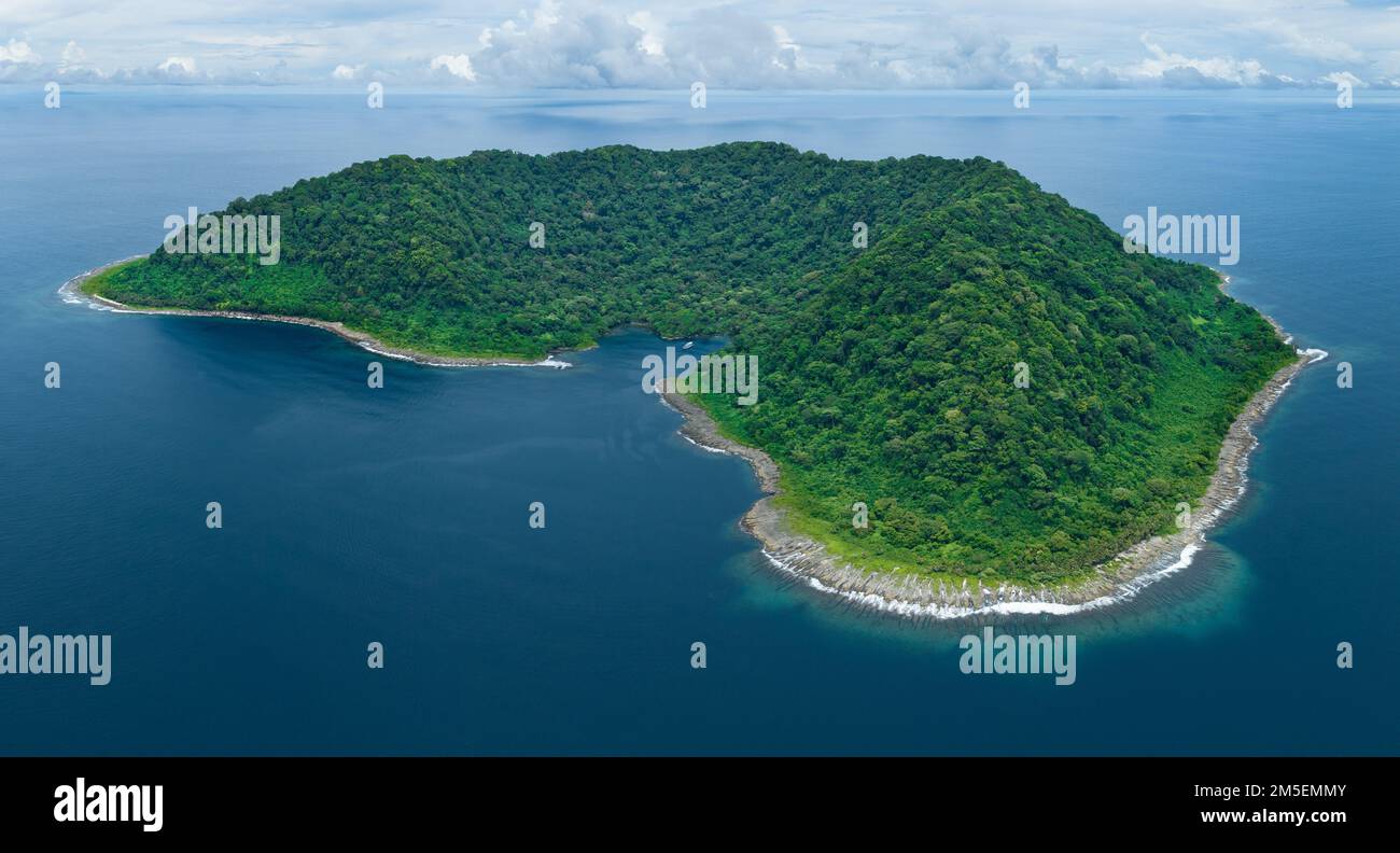 Rainforest covers the remote Mary Island which is fringed by a coral ...