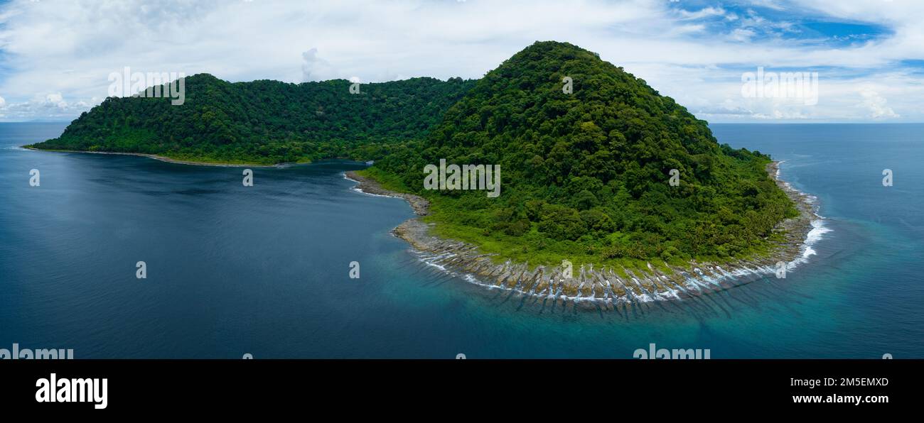 Rainforest covers the remote Mary Island which is fringed by a coral ...