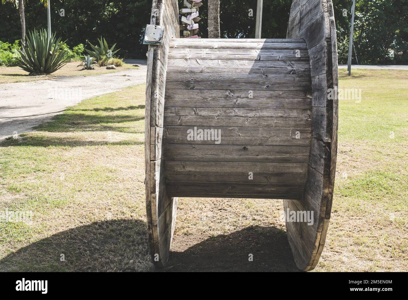 Empty wooden cable coil or spool for cable or rope standing on the side ...