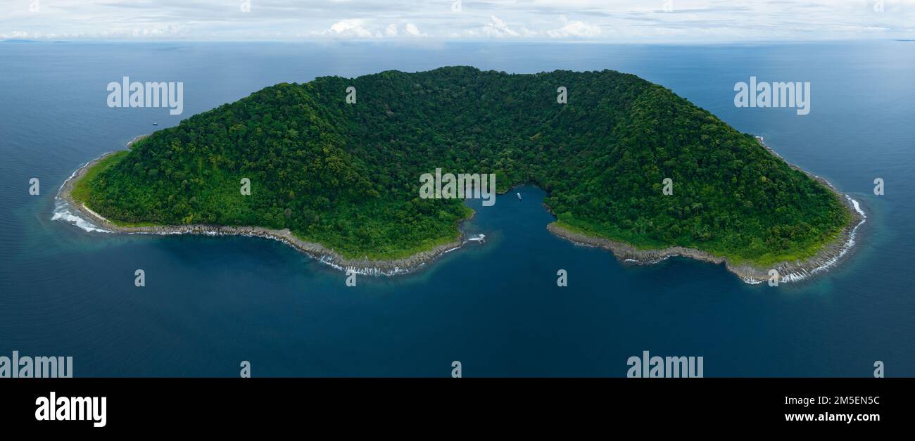 Rainforest covers the remote Mary Island which is fringed by a coral ...