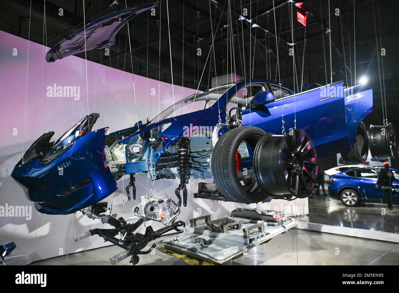 A Tesla Model Y hangs on display at the Petersen Automotive Museum ...