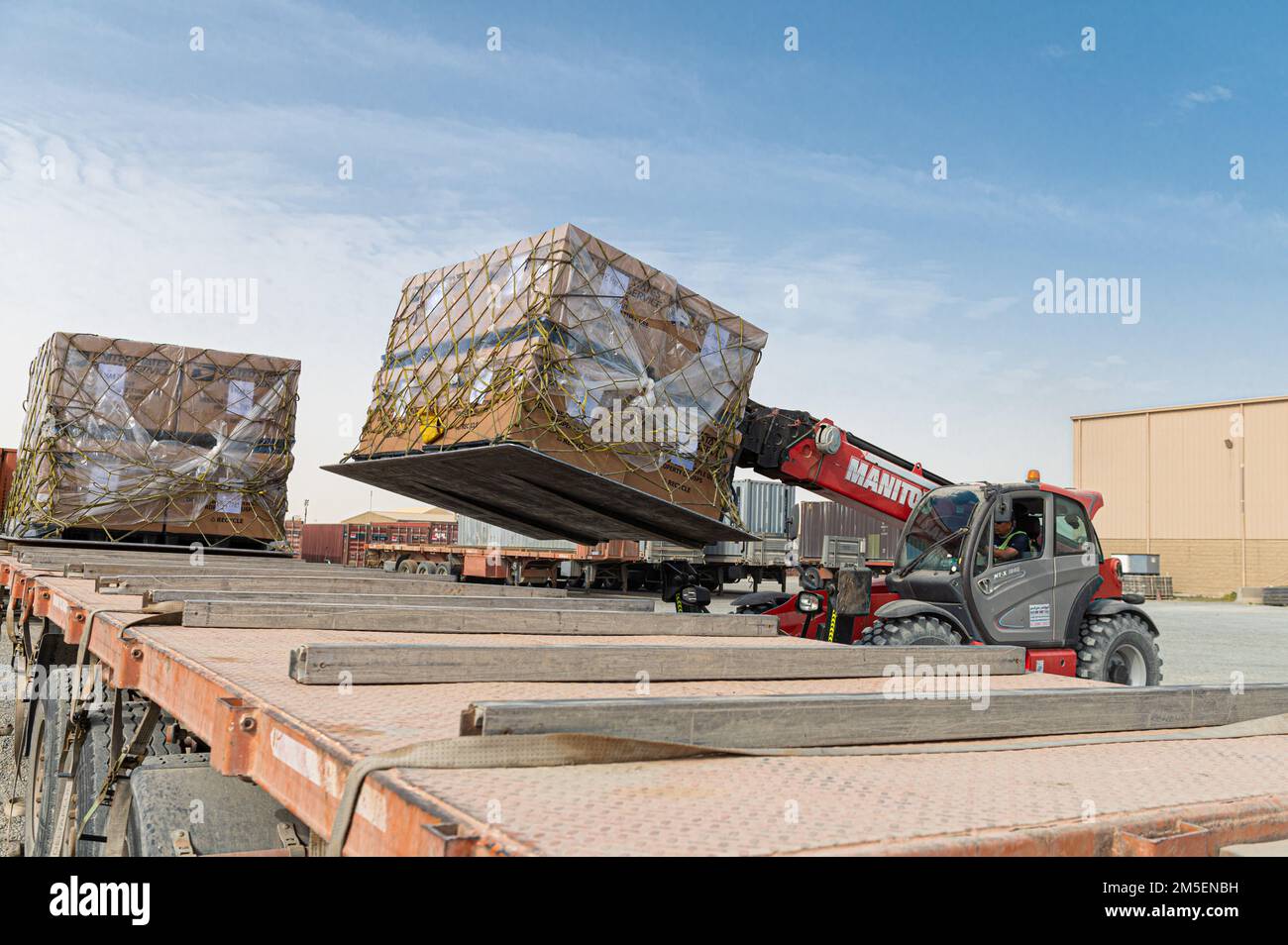 A forklift transports pallets from trailers to the Joint Military Mail ...