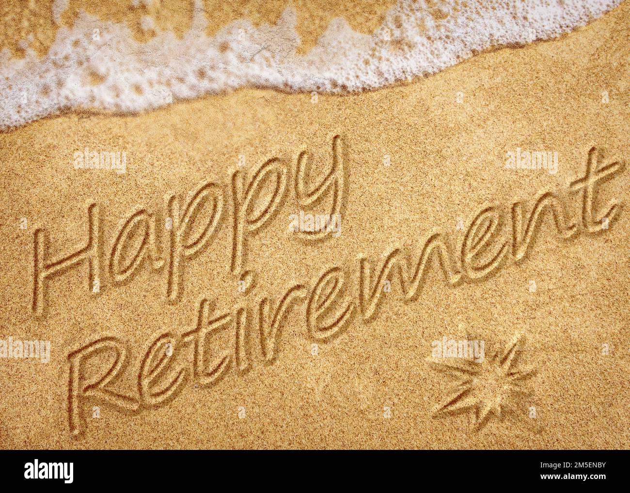 Happy Retirement message handwritten on smooth sand beach with gentle ...