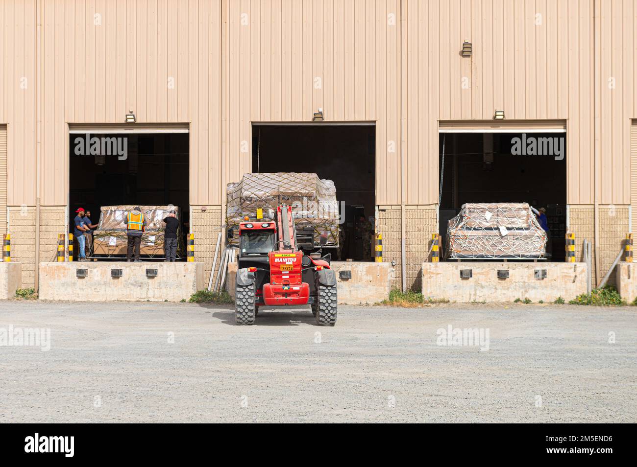 A forklift transports pallets from trailers to the Joint Military Mail ...