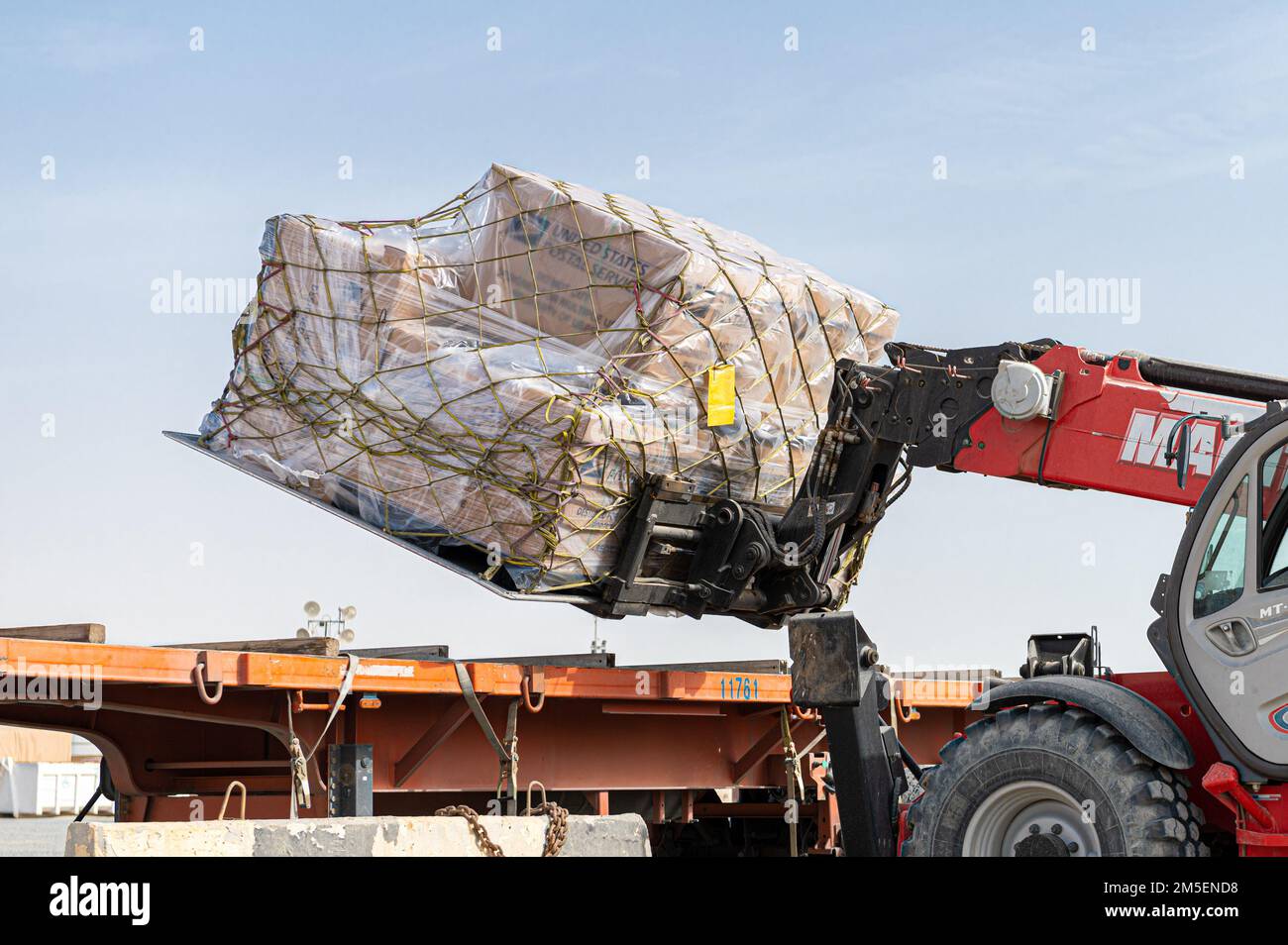 A forklift transports pallets from trailers to the Joint Military Mail ...