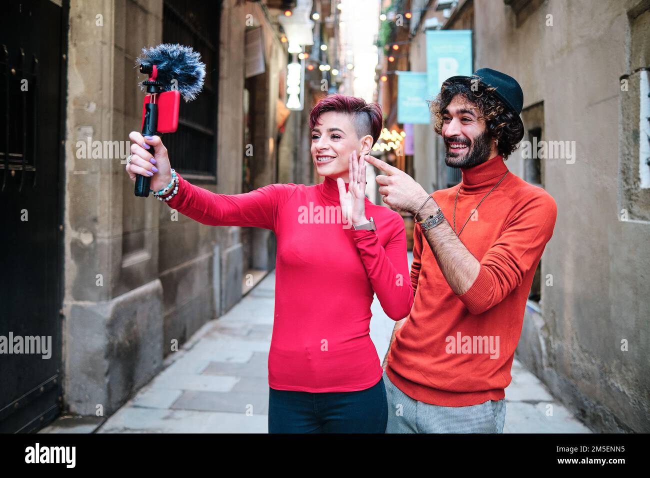 Two people recording an online video with a mobile outdoors Stock Photo ...