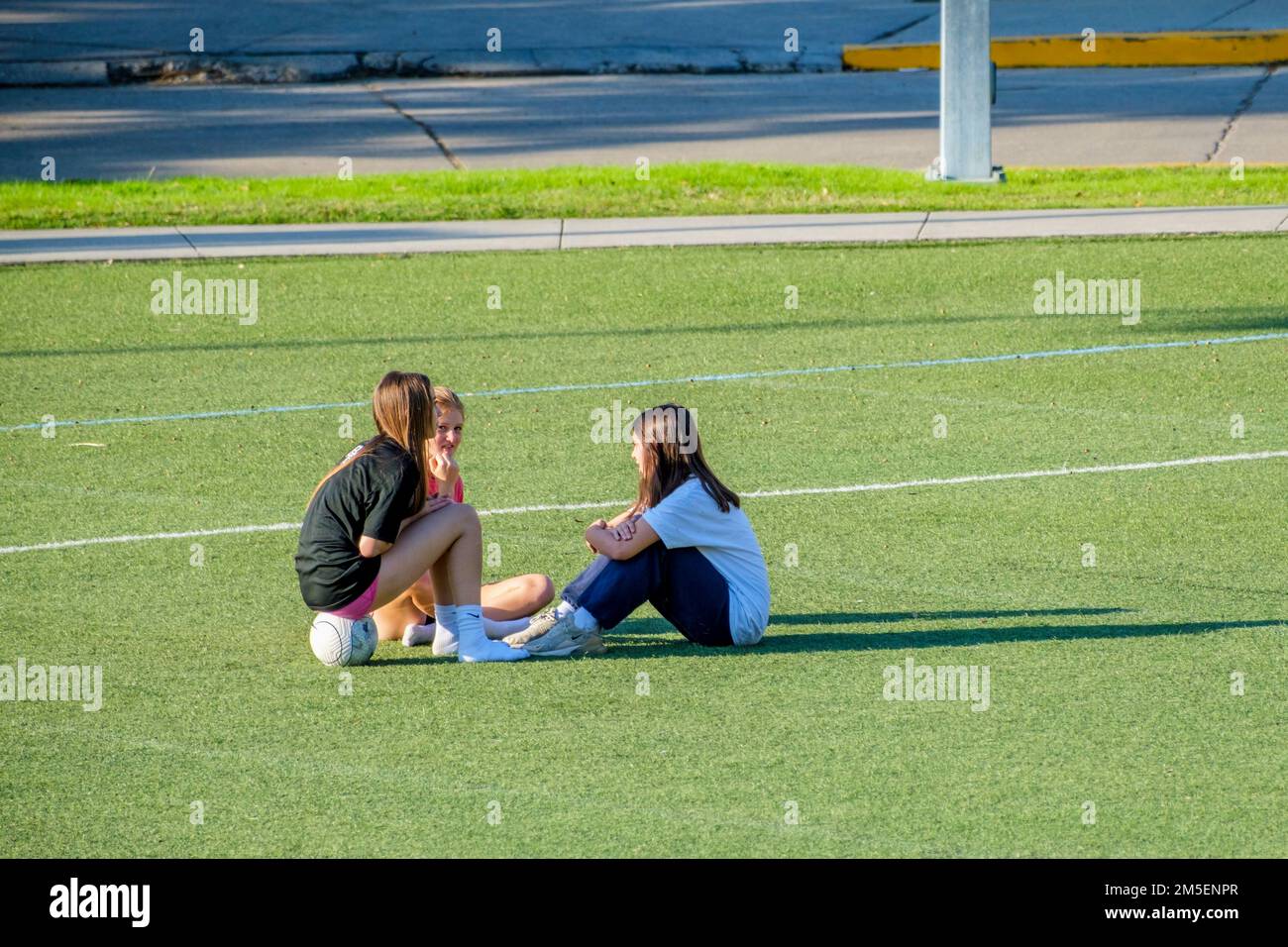 NEW ORLEANS, LA, USA - DECEMBER 16, 2022: Three teenage girls sitting ...