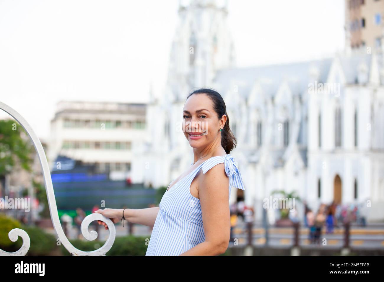 Beautiful tourist woman at the Ortiz Bridge with La Ermita church on ...