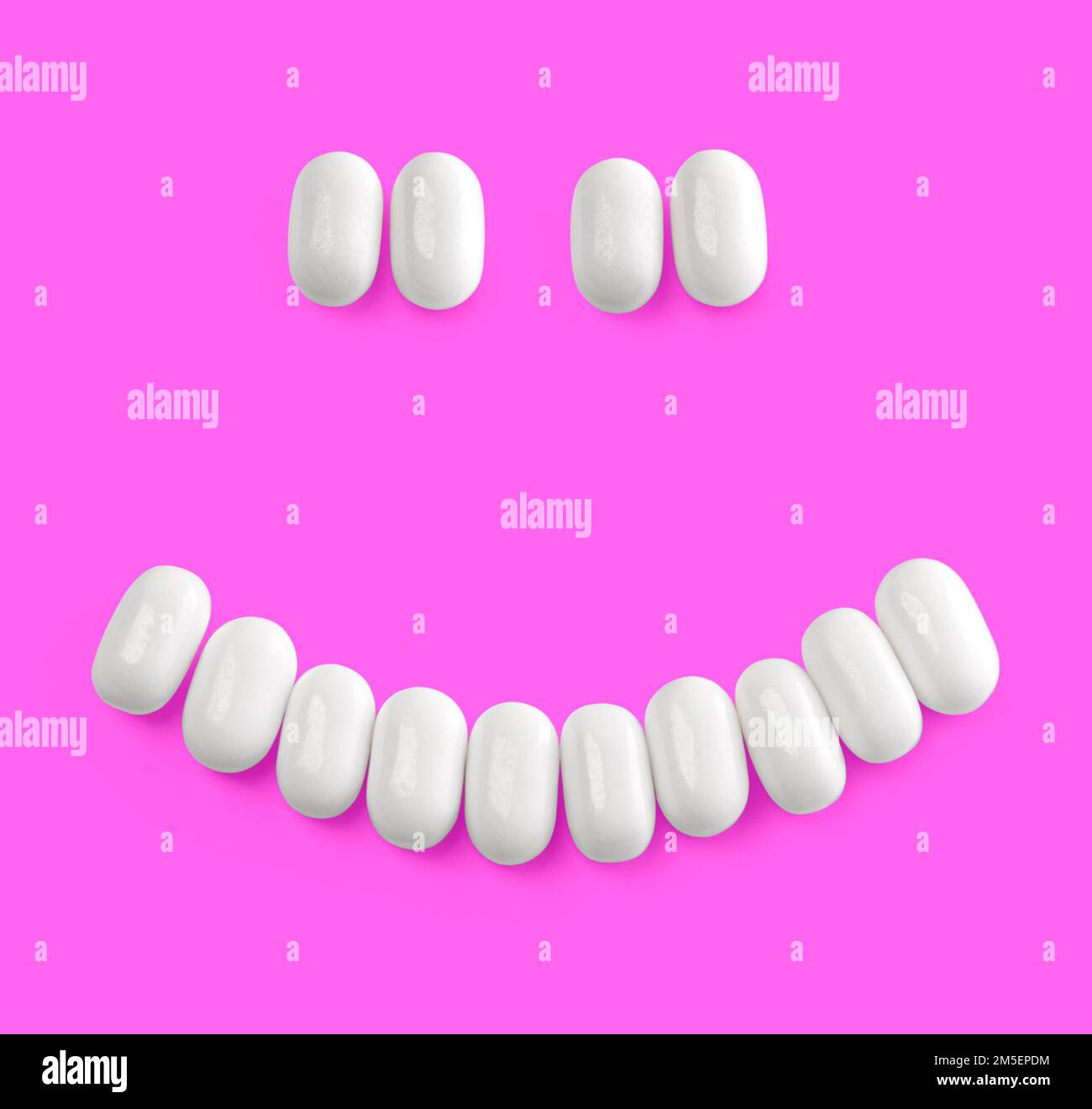 White candy chewing gum on a pink background Stock Photo - Alamy