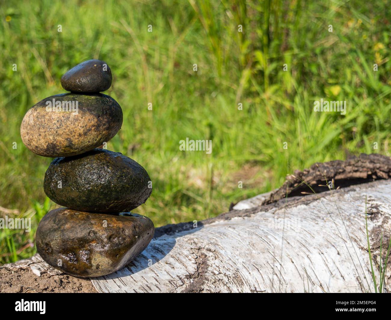 Balance stones in a meadow Stock Photo - Alamy