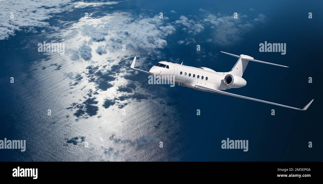 Airliner flying above blue waters of the Atlantic Ocean. Sunlight is ...