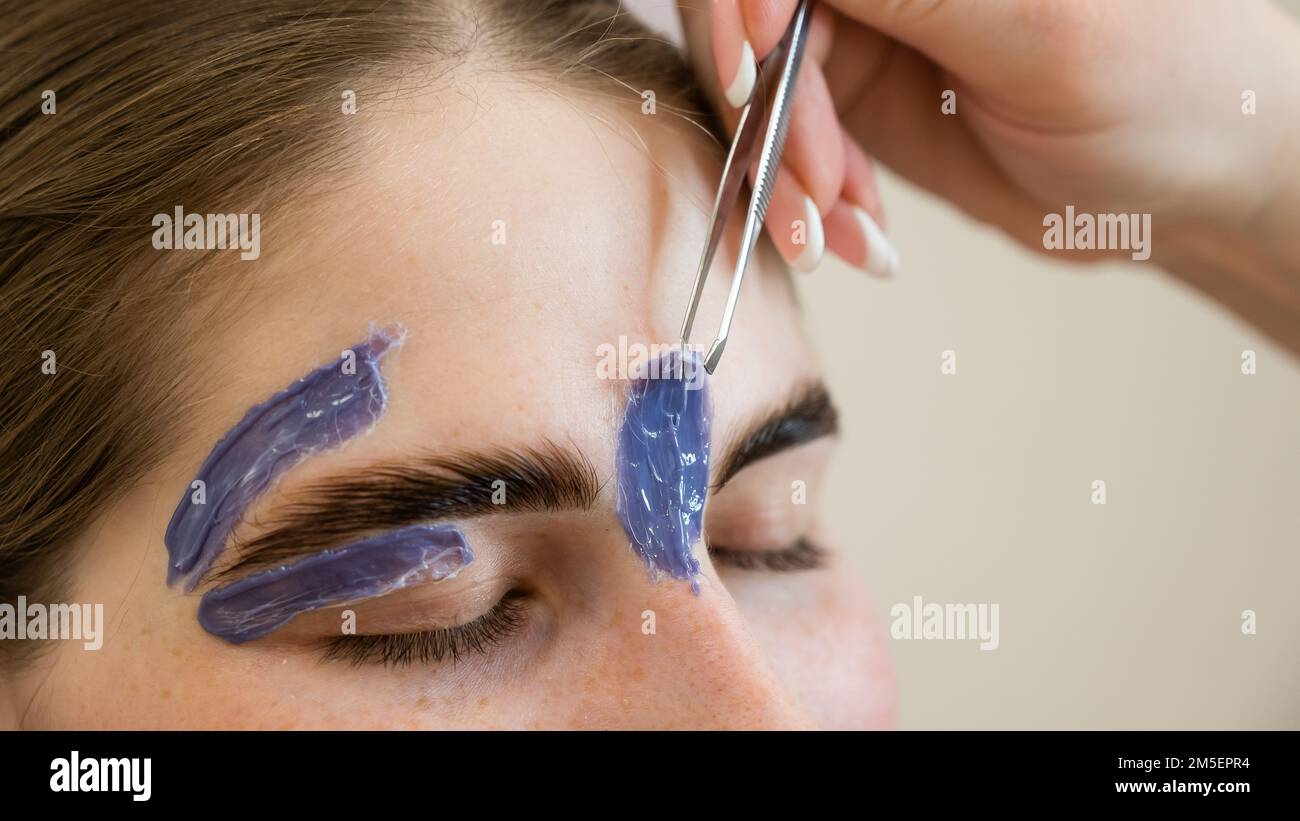 The master removes the composition for lamination from the client's ...