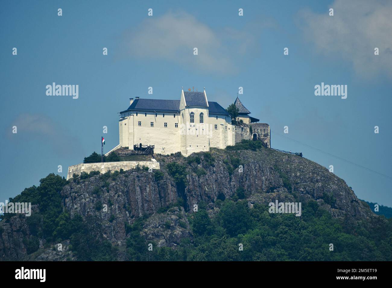 The medieval Fuzer castle in Hungary on top of a hill against the blue ...