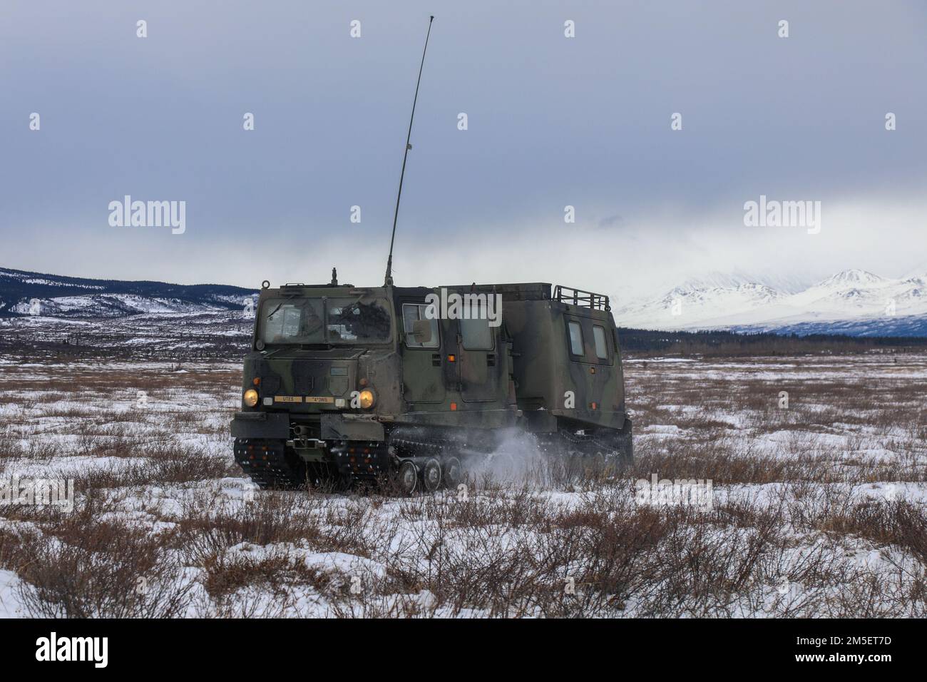 A Small Unit Support Vehicle (SUSV) moves across the drop zone after ...