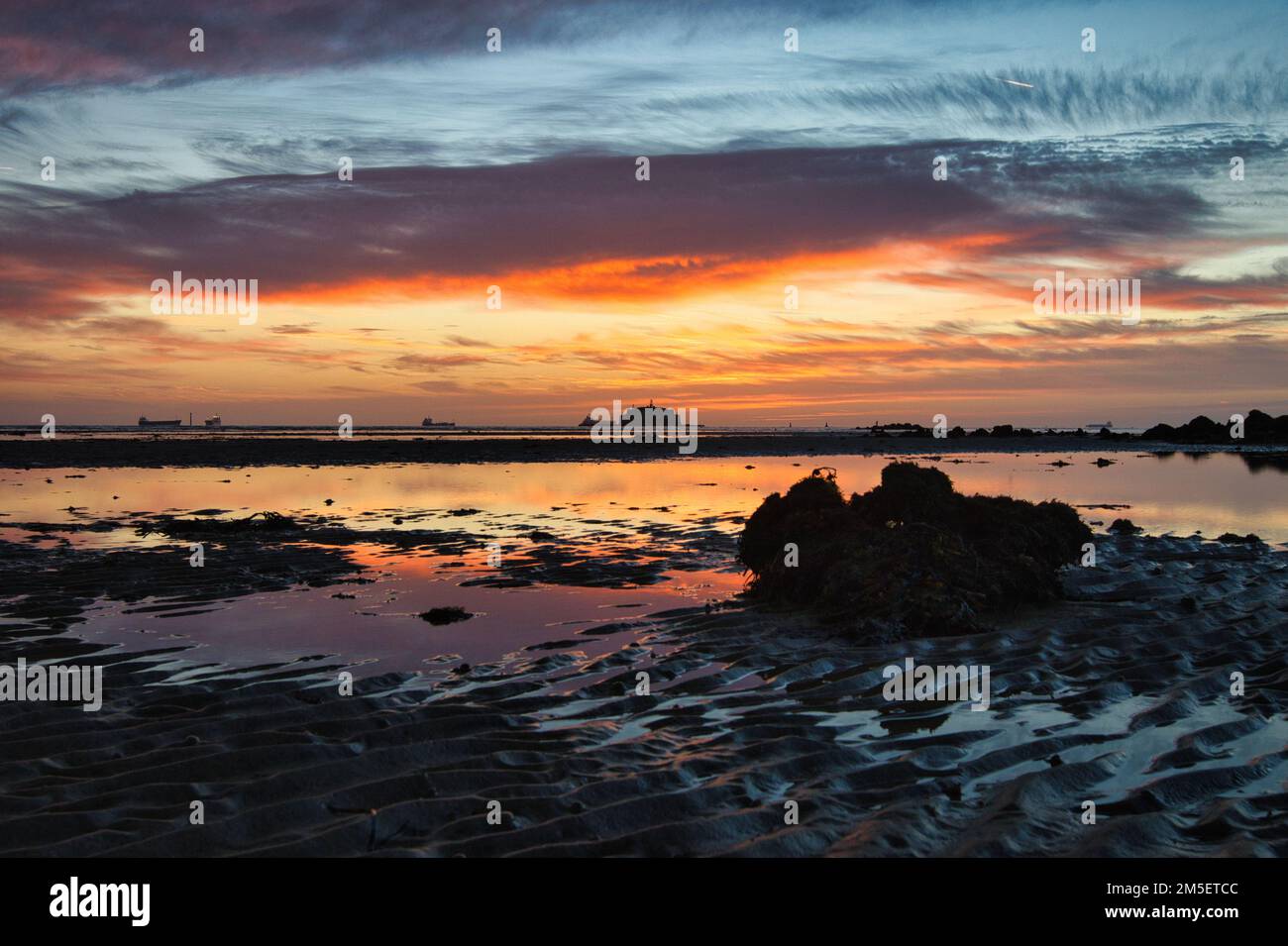 A landscape view of the beach at sunrise. Isle of Wight Stock Photo - Alamy