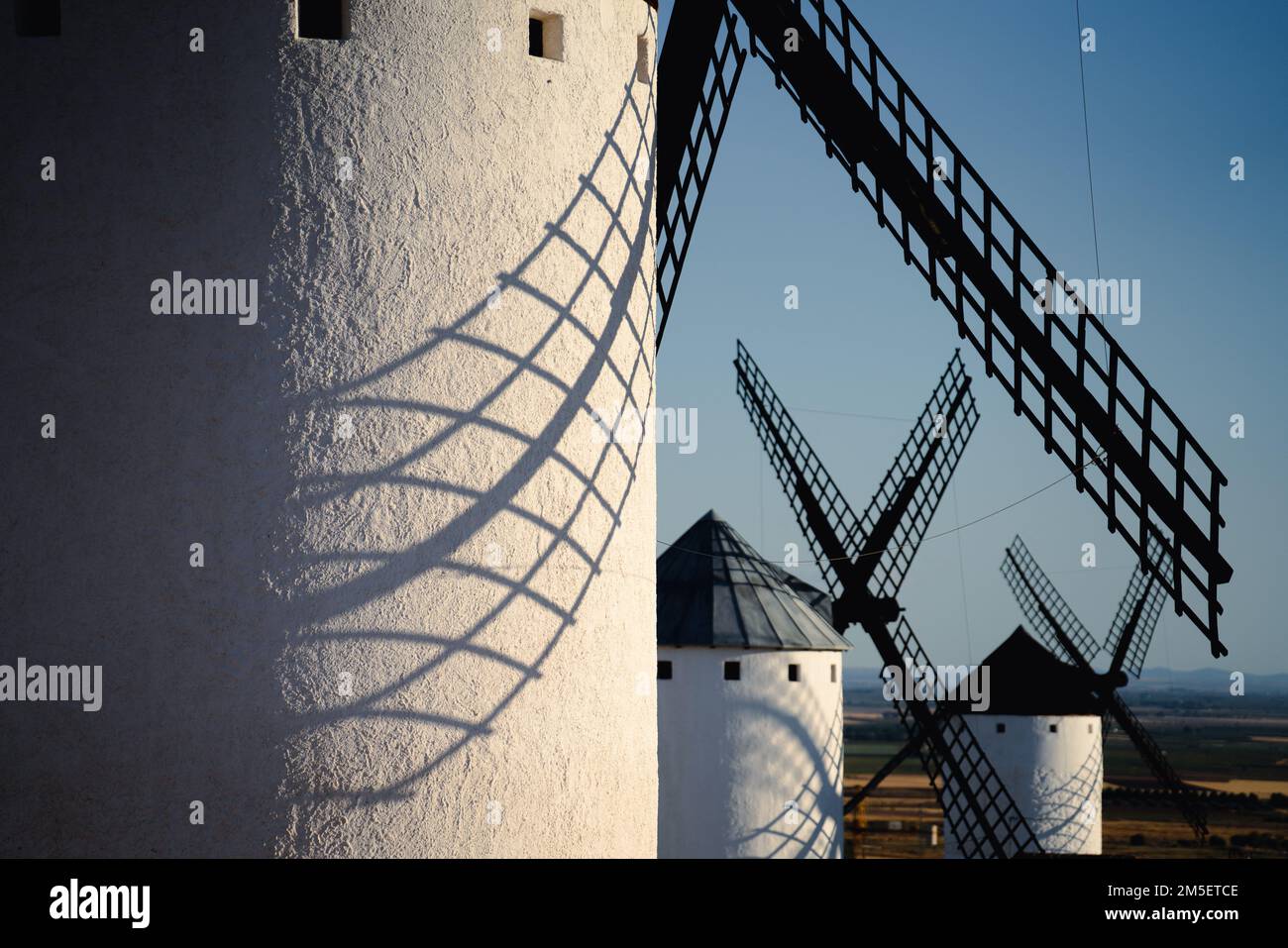 Old windmills in a row at sunset Stock Photo - Alamy