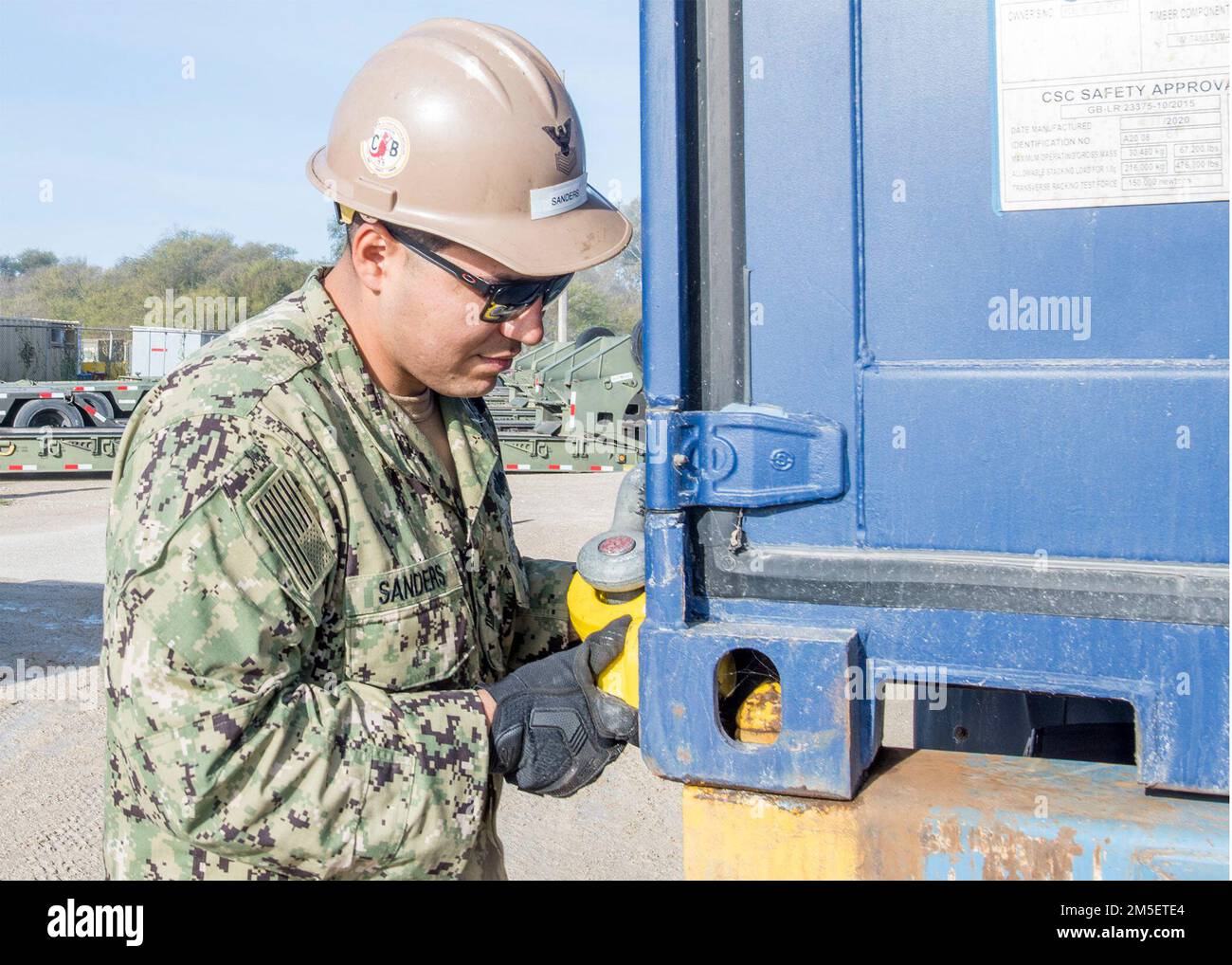 Equipment Operator 1st Class Victor Sanders secures a 40’ ISO container ...